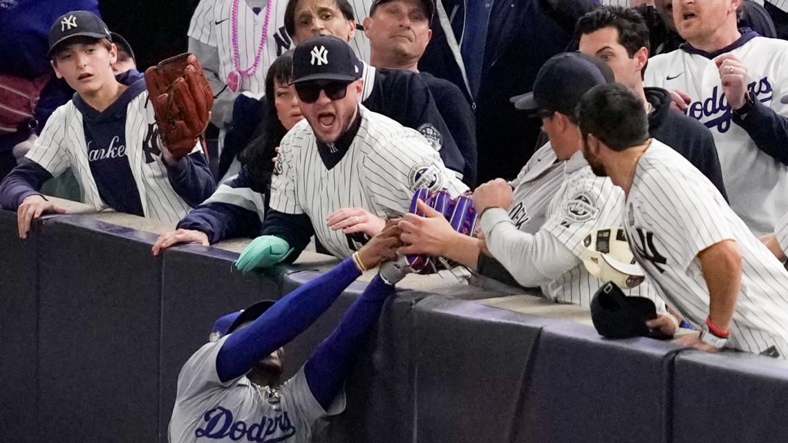 Fans try to rip ball from Dodgers player's glove, get ejected | abc10.com