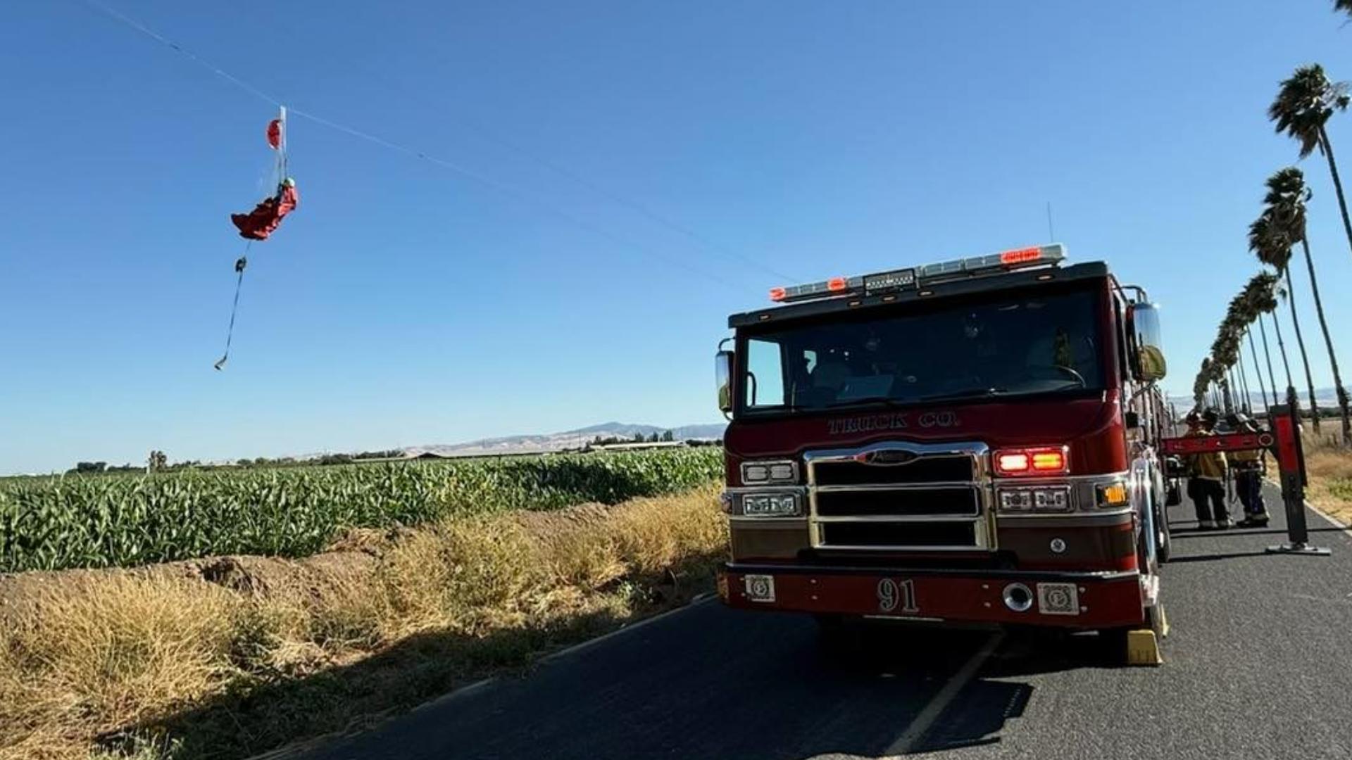 Skydiver tangled in Tracy power lines, suspended over roadway | abc10.com