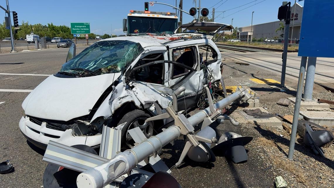 Minivan hit by light rail train while trying to pass rail crossing ...